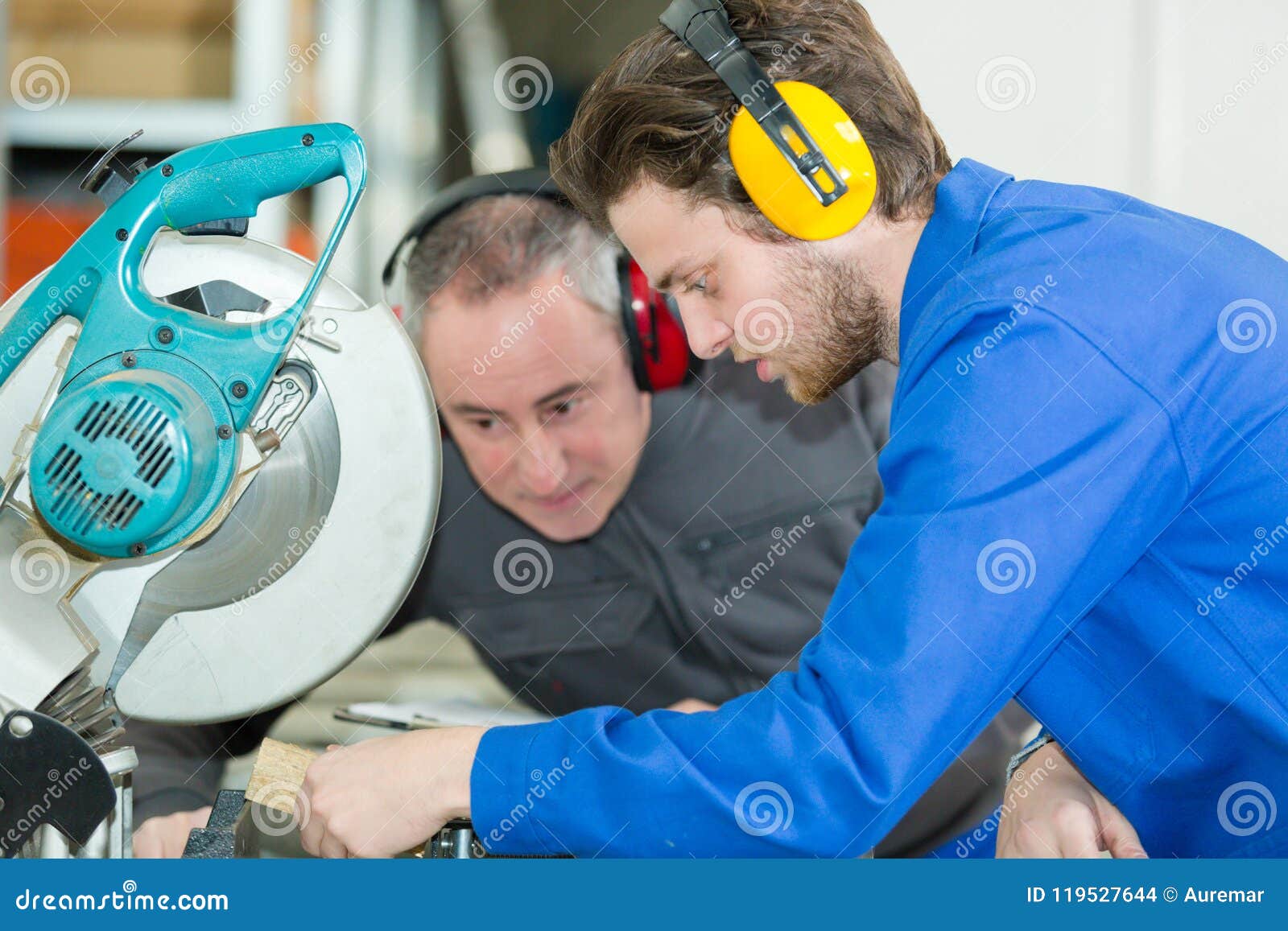 Supervisor Overseeing Apprentice Using Circular Saw Stock Photo - Image ...