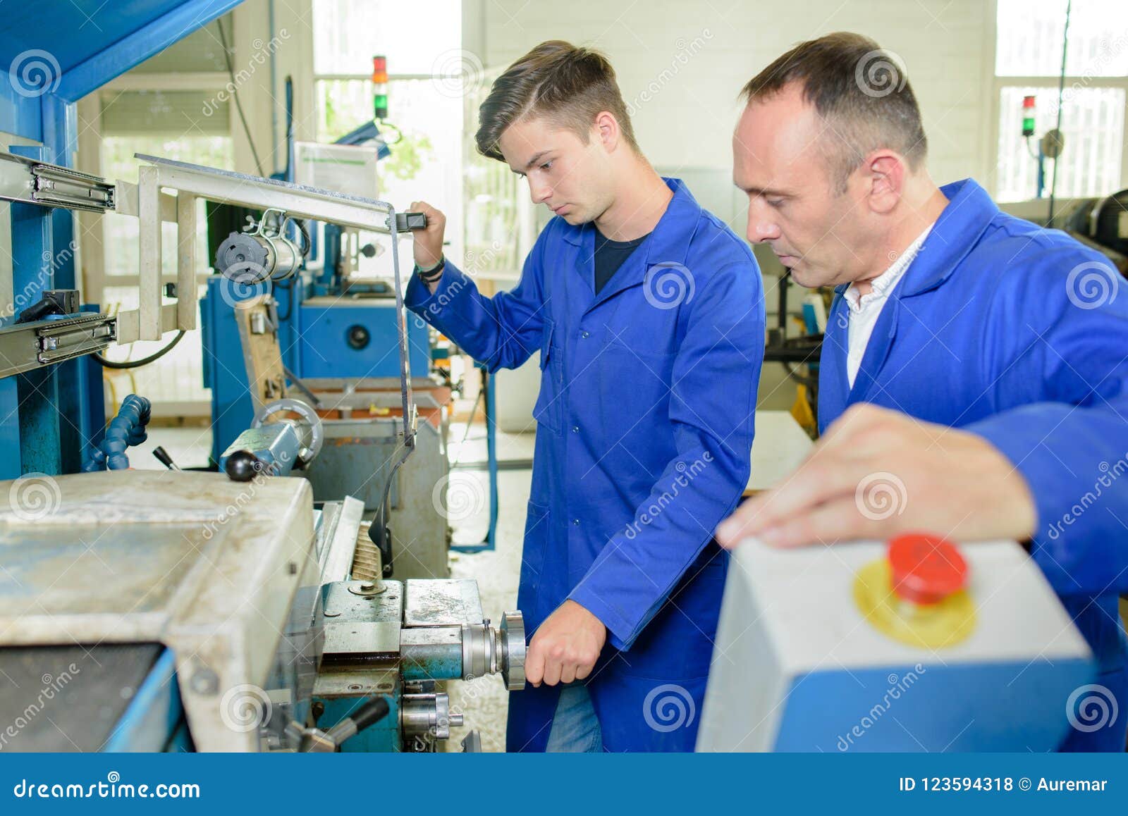 Supervisor Overseeing Apprentice Using Machinery Stock Photo - Image of ...
