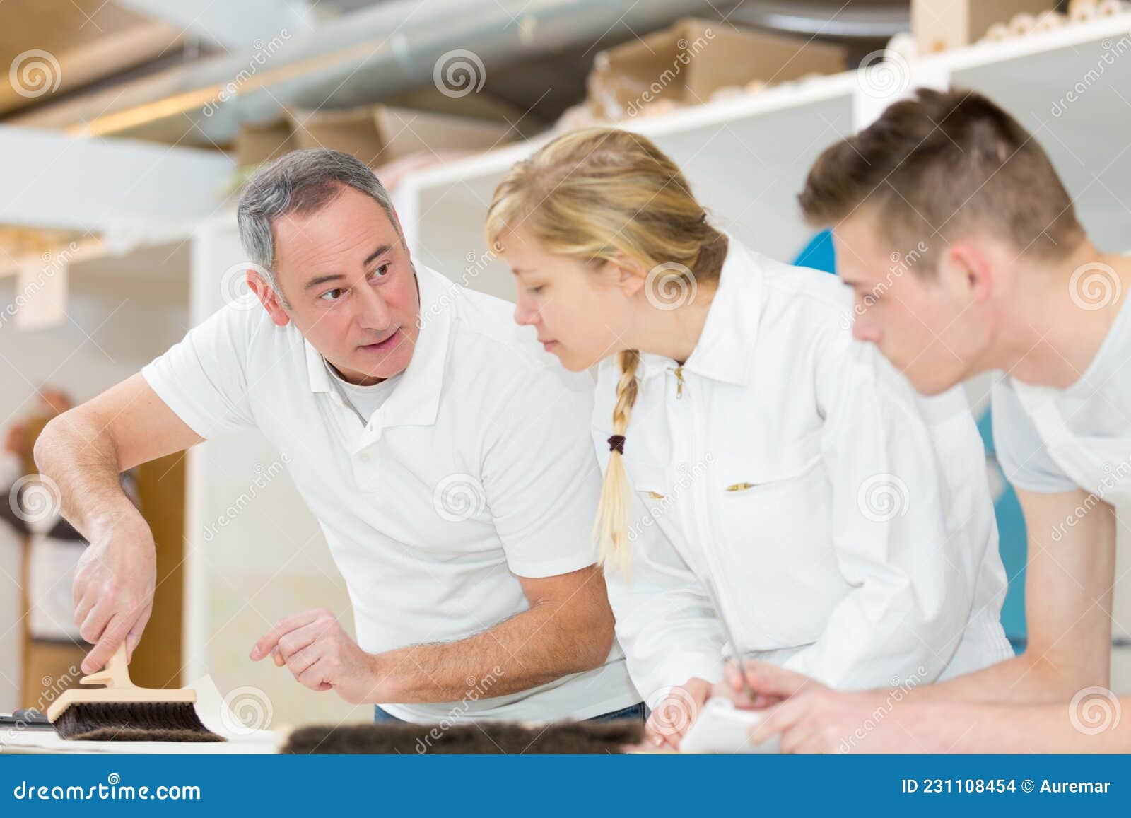 Supervisor Showing Apprentices How To Use Wallpaper Brush Stock Photo ...