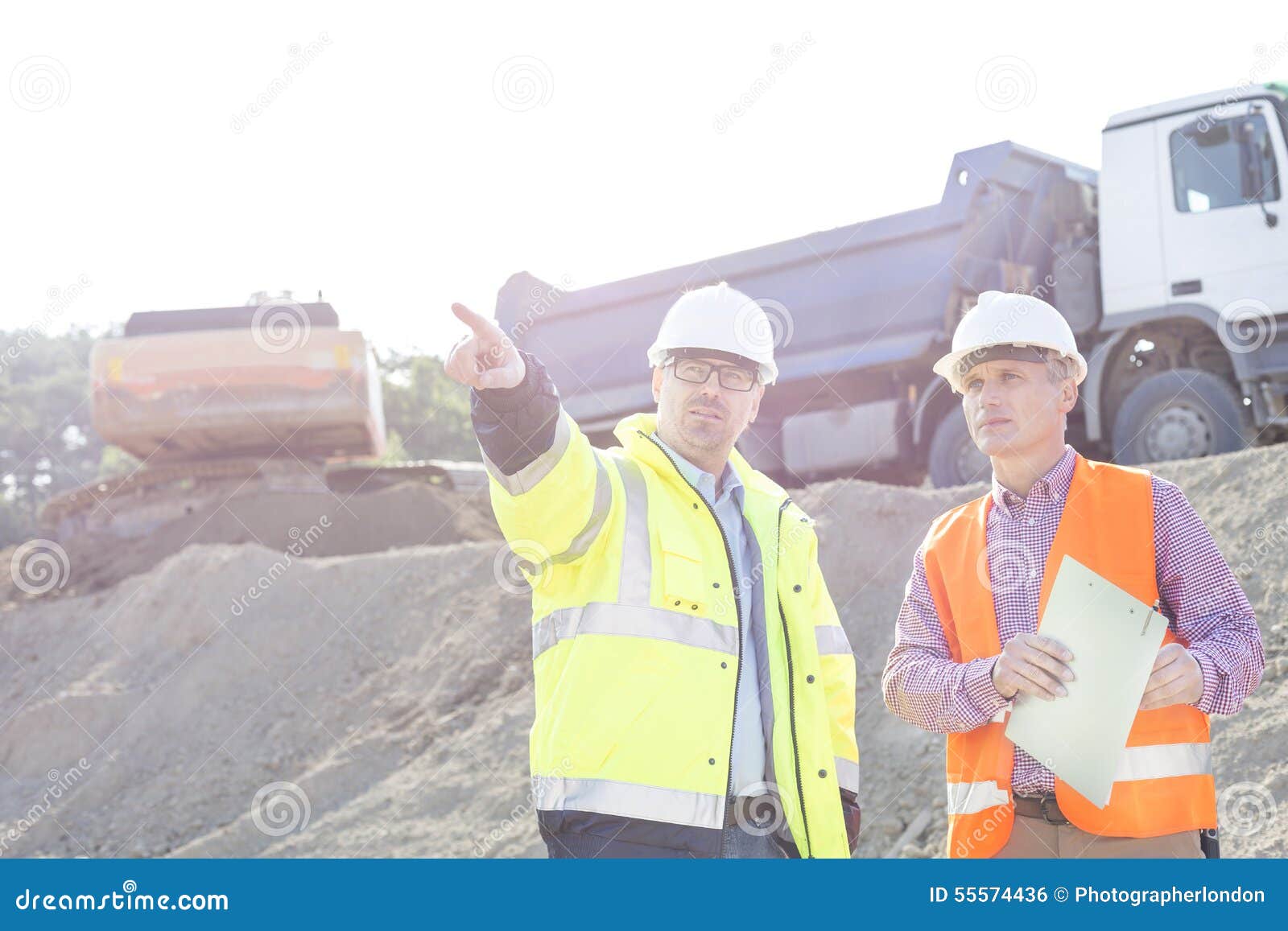 Supervisor Showing Something To Colleague while Discussing at ...