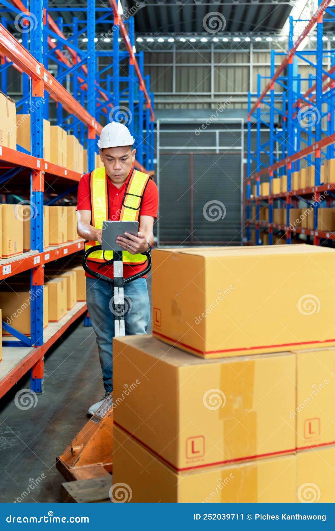 Supervisor Standing in Warehouse with Tablet in Hands and Checking Out ...