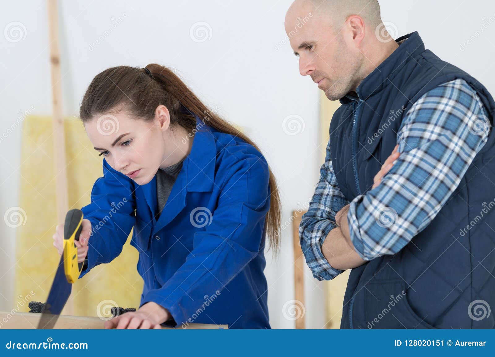 Supervisor Watching Apprentice Use Handsaw Stock Image - Image of ...