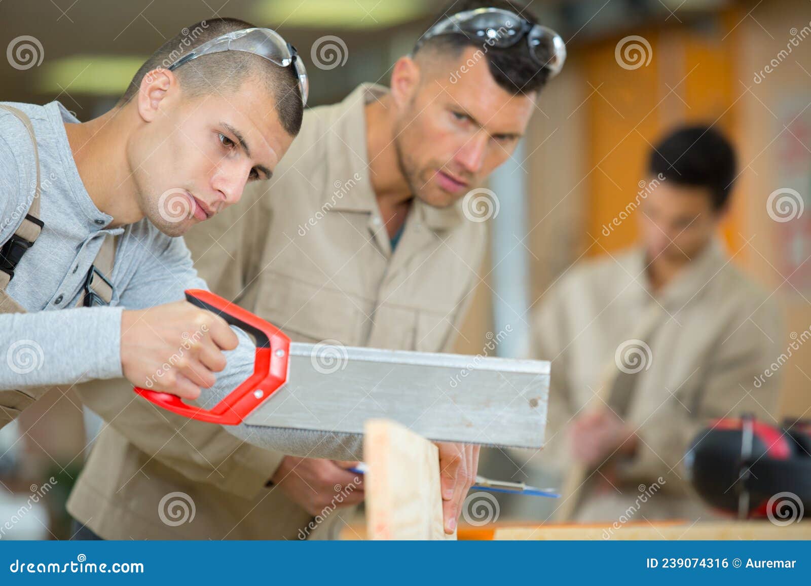 Supervisor Watching Apprentice Using Manual Saw Stock Photo - Image of ...