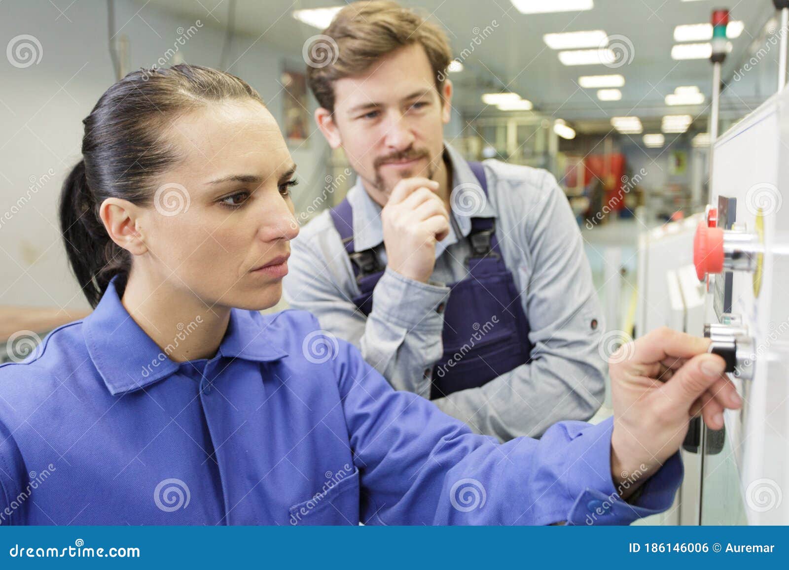 Supervisor Watching Female Worker Using Machinery Control Panel Stock ...