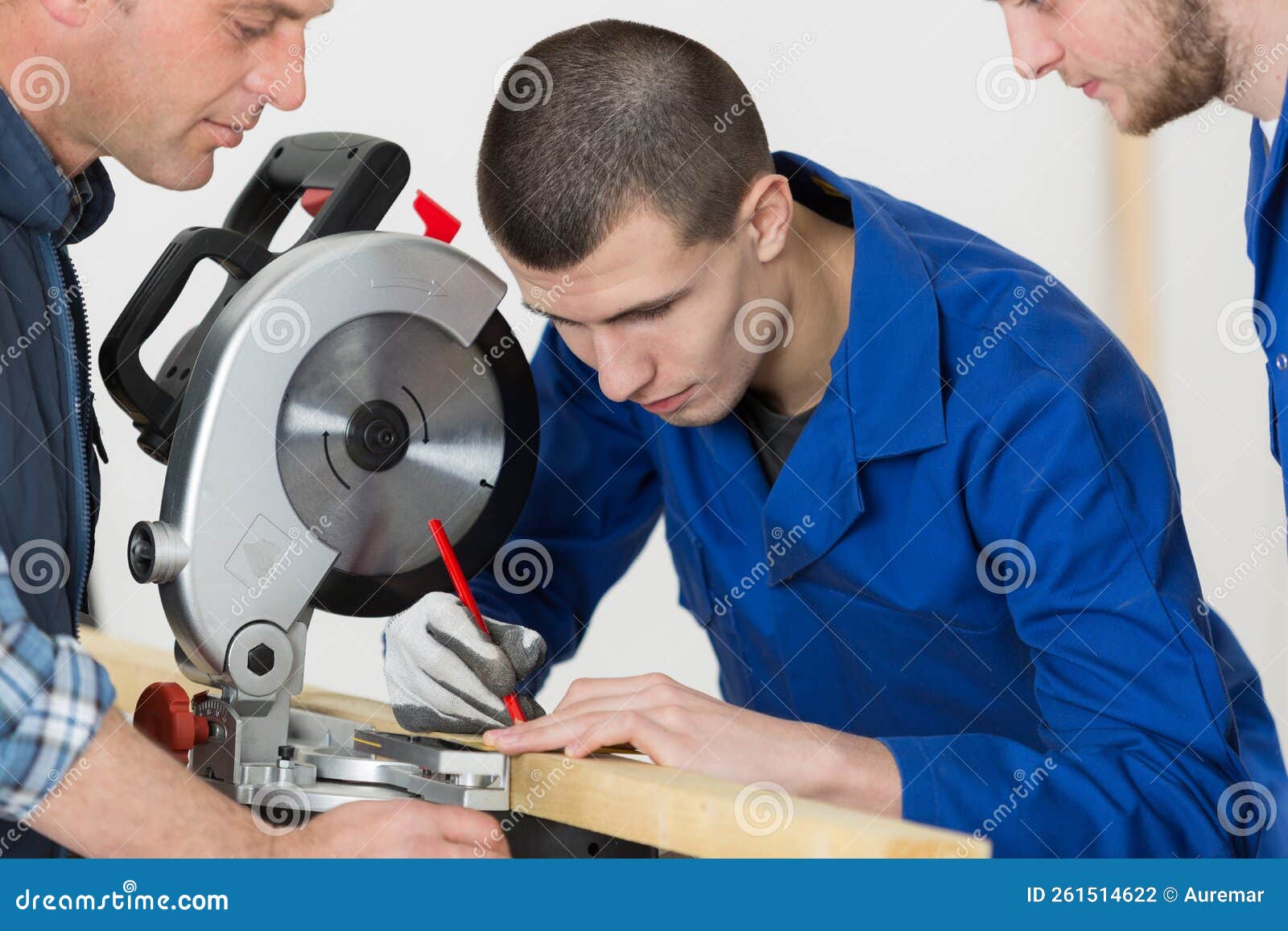 Supervisor Watching Over Apprentice Preparing To Use Ciscular Saw Stock ...