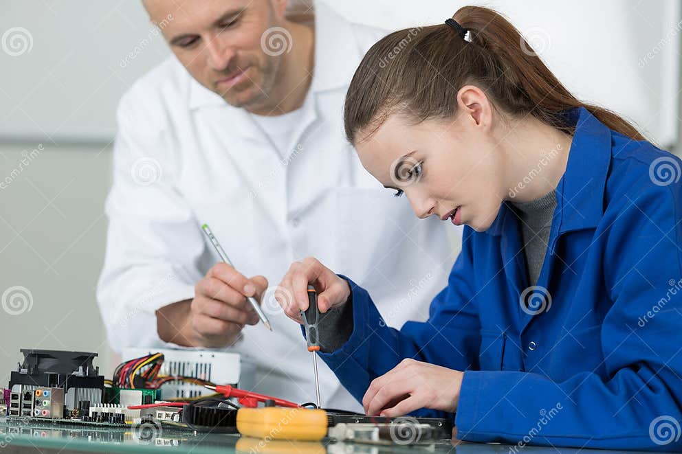 Supervisor Watching Over Electronics Students at Work Stock Photo ...