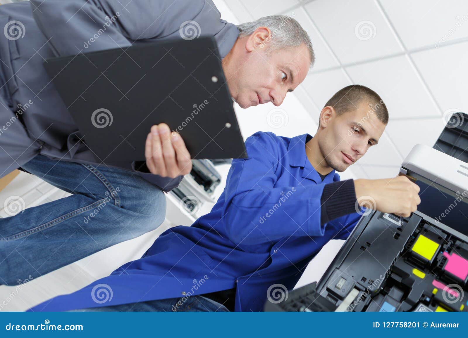 Supervisor Watching Technician Work on Photocopier Stock Image - Image ...