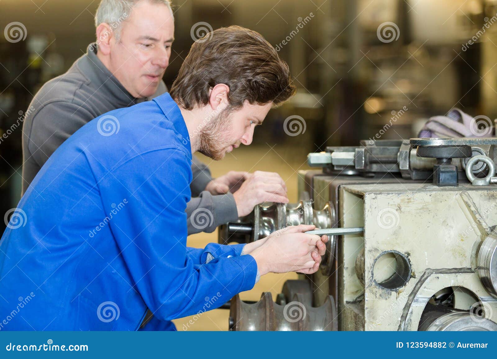 Supervisor Watching Trainee Work on Machine Stock Photo - Image of ...