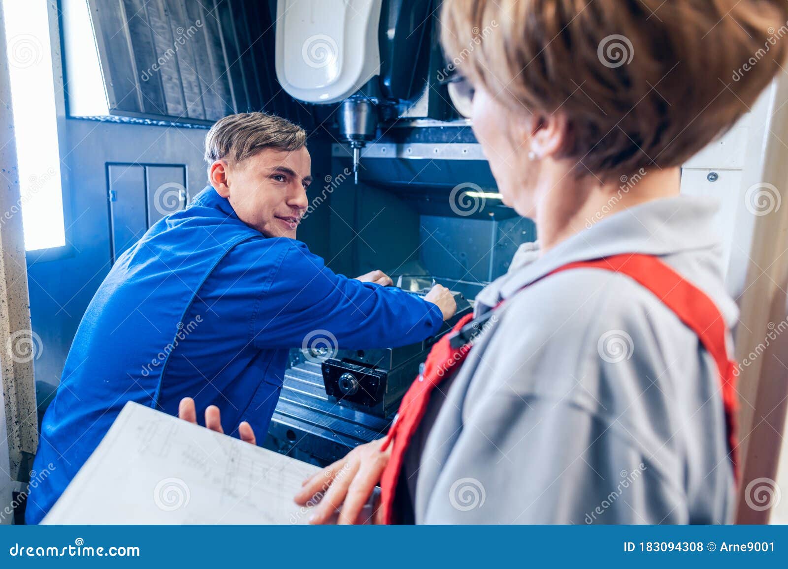 Supervisor Watching Young Worker Changing Setup of Lathe Machine Stock ...