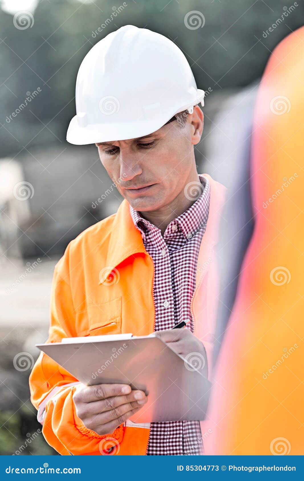 Supervisor Writing on Clipboard at Construction Site Stock Image ...