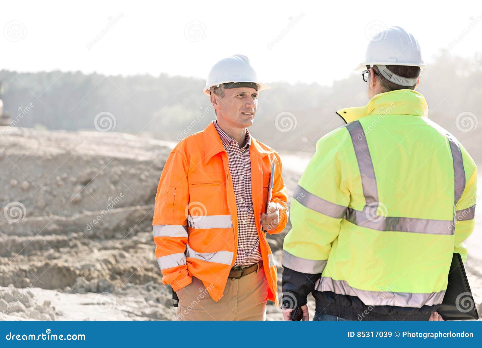 Supervisors Discussing at Construction Site on Sunny Day Stock Image ...