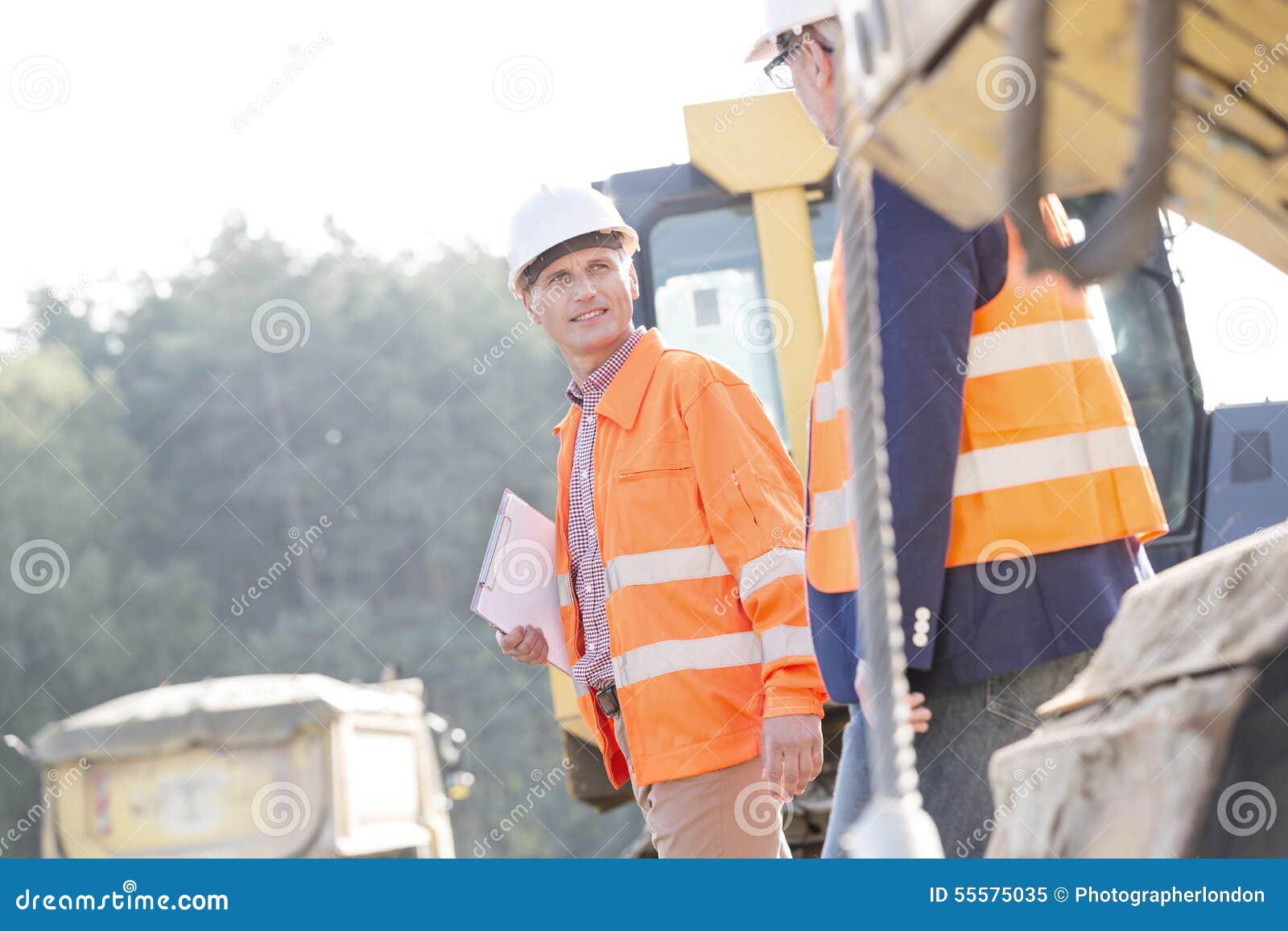 Supervisors Discussing while Walking at Construction Site Stock Image ...