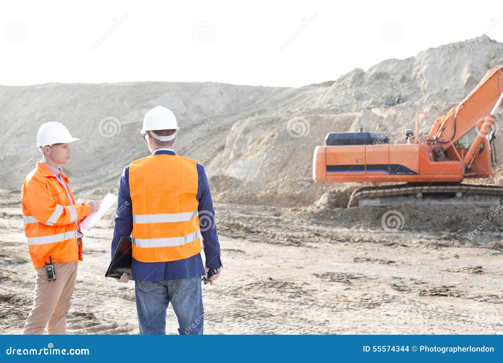 Supervisors Standing at Construction Site Against Clear Sky Stock Photo ...