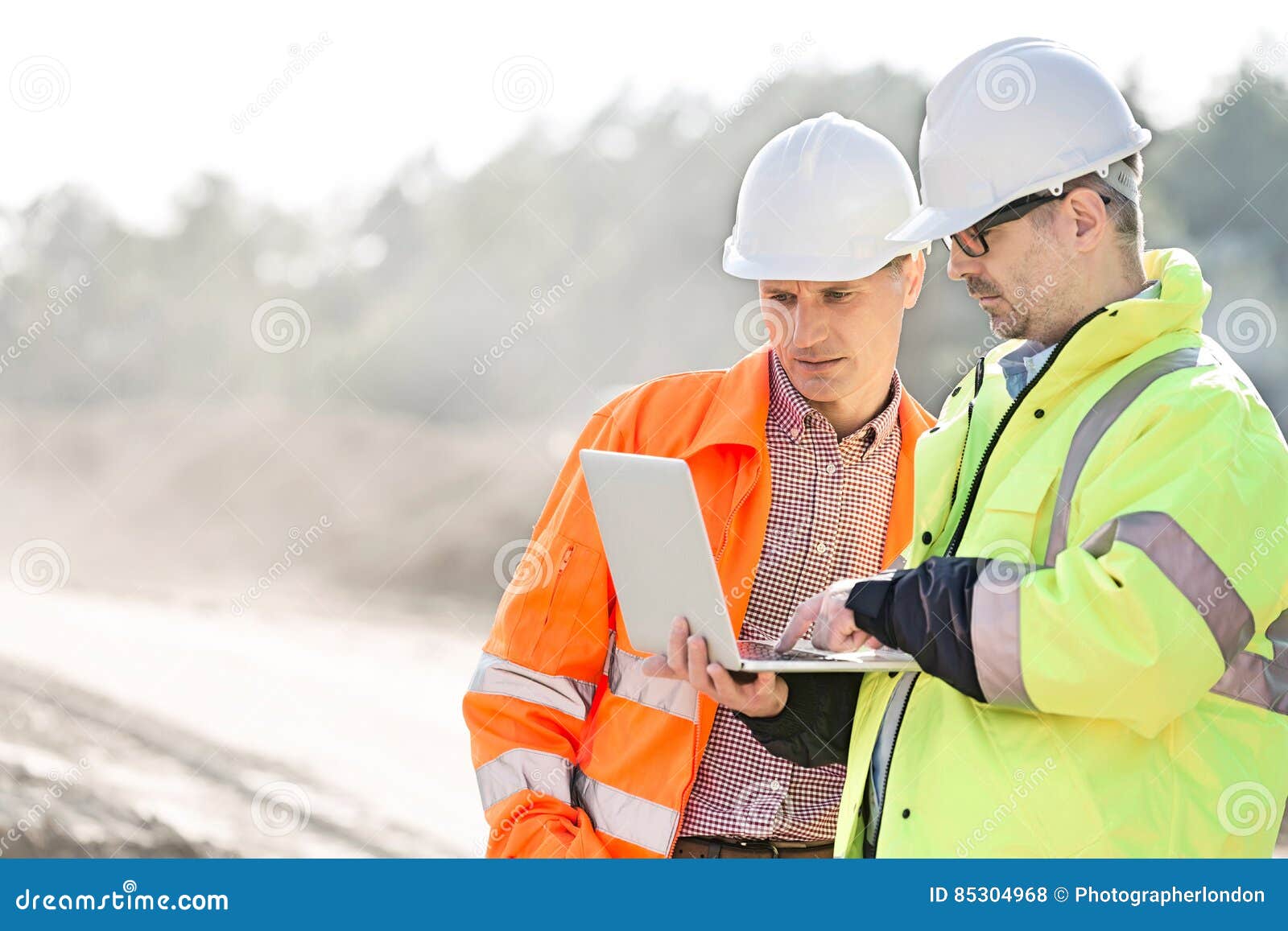 Supervisors Using Laptop at Construction Site Stock Photo - Image of ...