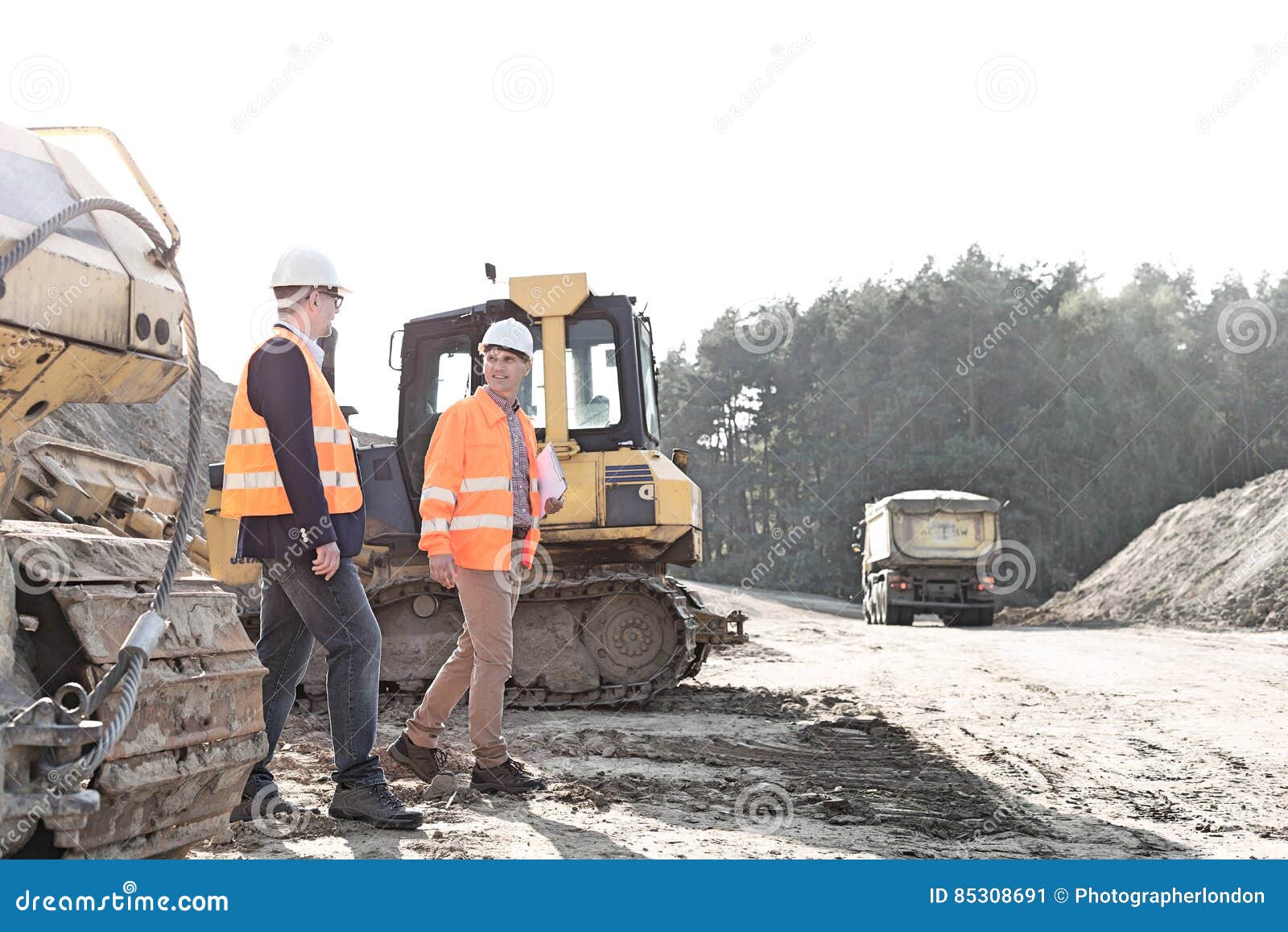 Supervisors Walking at Construction Site Against Clear Sky Stock Image ...