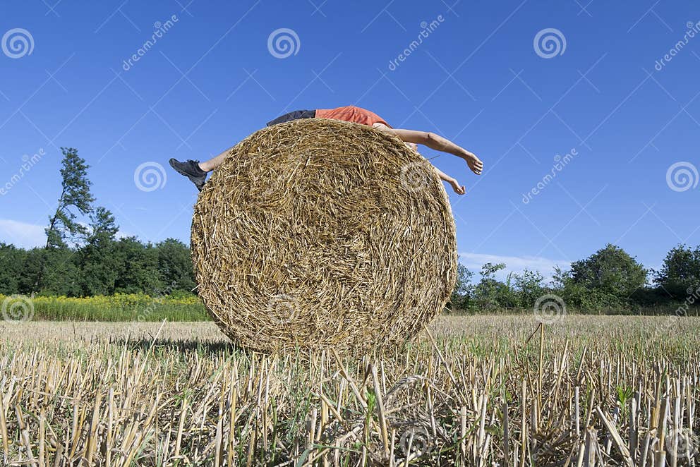 Supine man on Hay bale stock image. Image of outdoor - 25859109