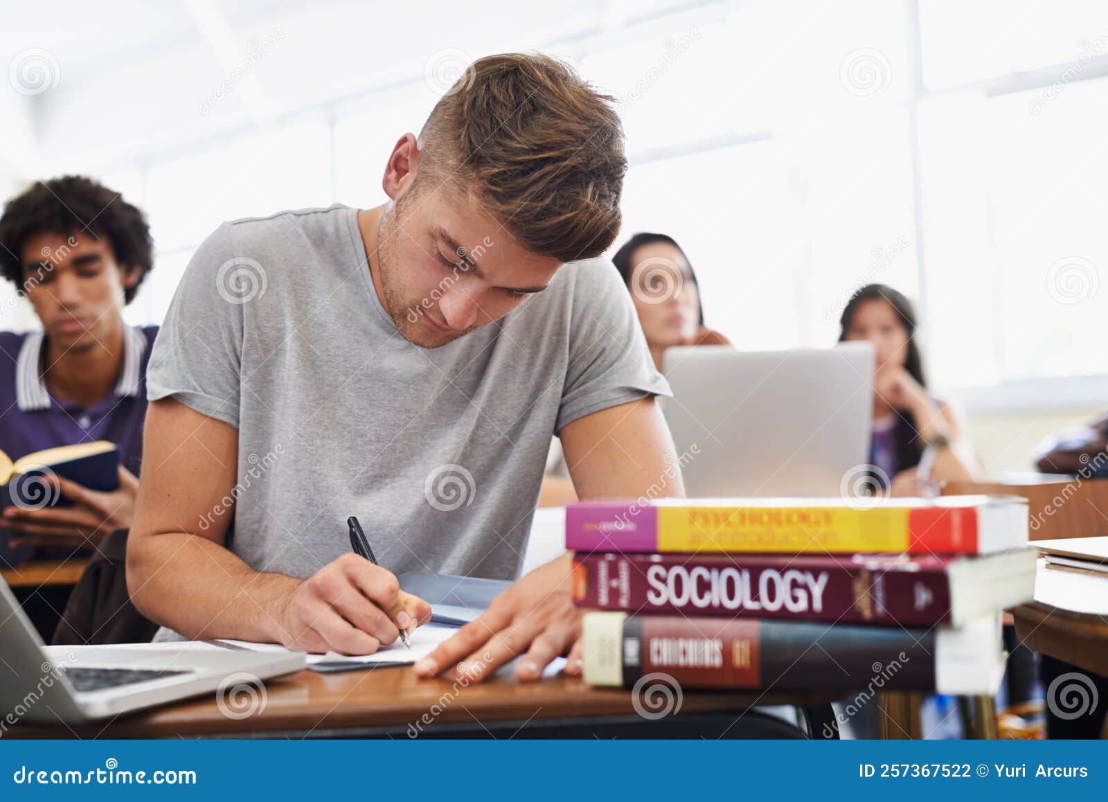 Sure of Study Success. a Handsome Young Student Sitting at a Desk with ...