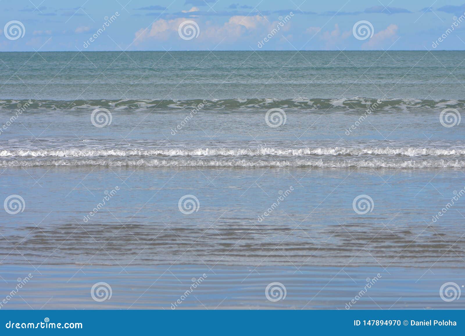 Surf coming on flat beach stock photo. Image of coastal - 147894970