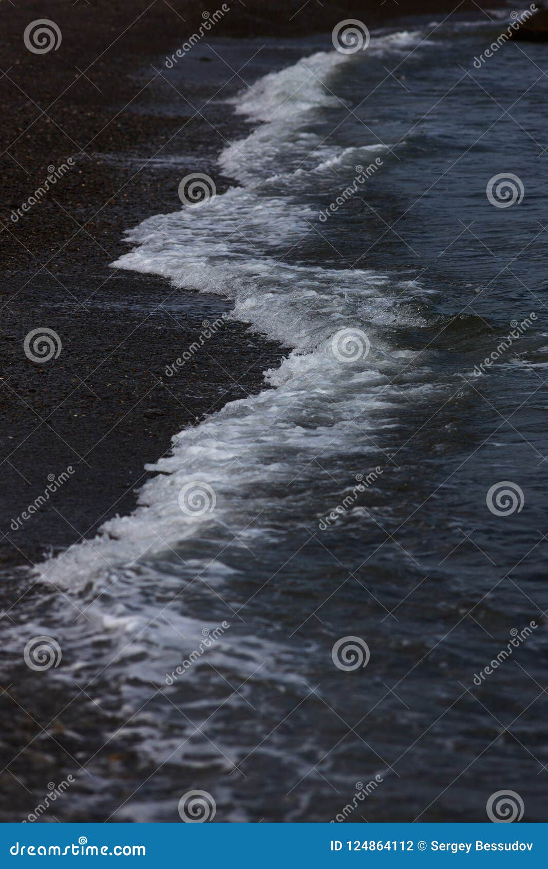 The Surf Wave Line on a Dark Pebble Beach in the Evening Stock Photo ...