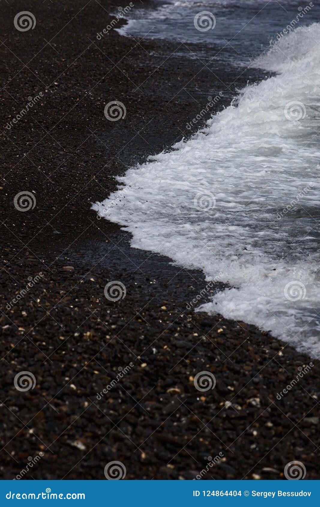 The Surf Wave Line on a Dark Pebble Beach in the Evening Stock Photo ...