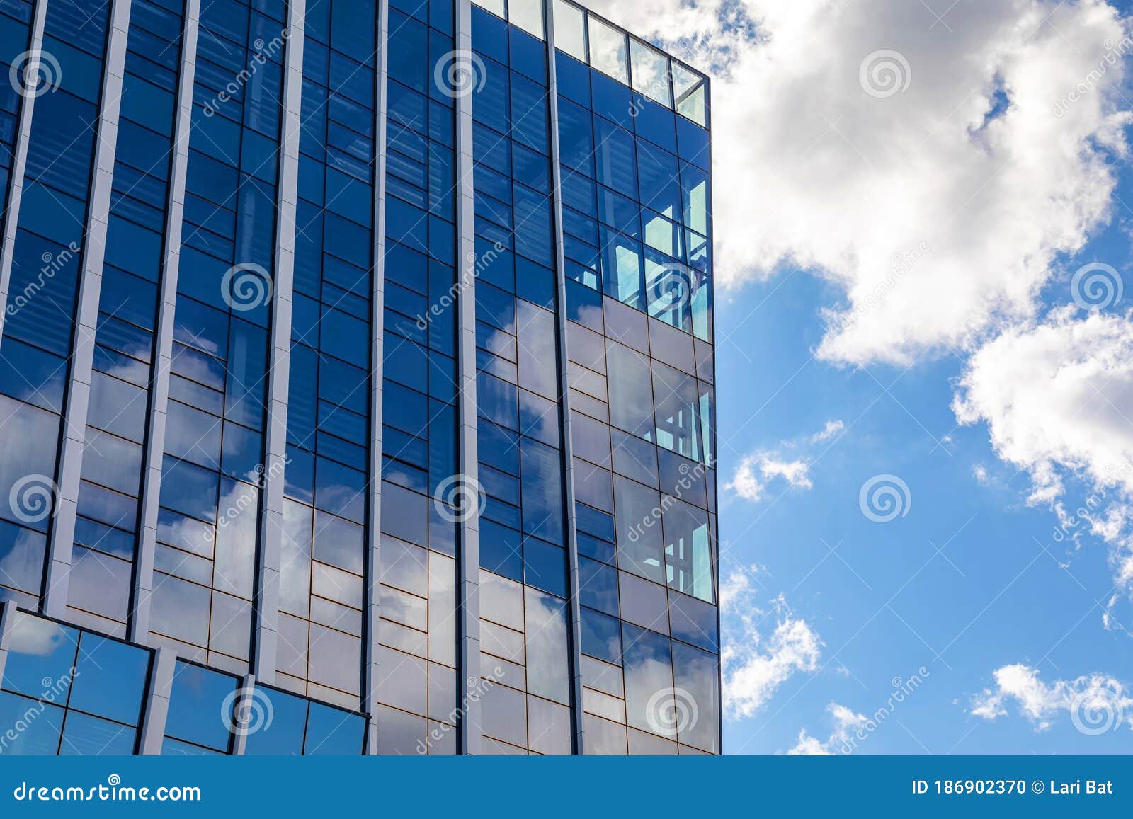 The Surface of a Glass High-rise Building with Reflection of Clouds ...