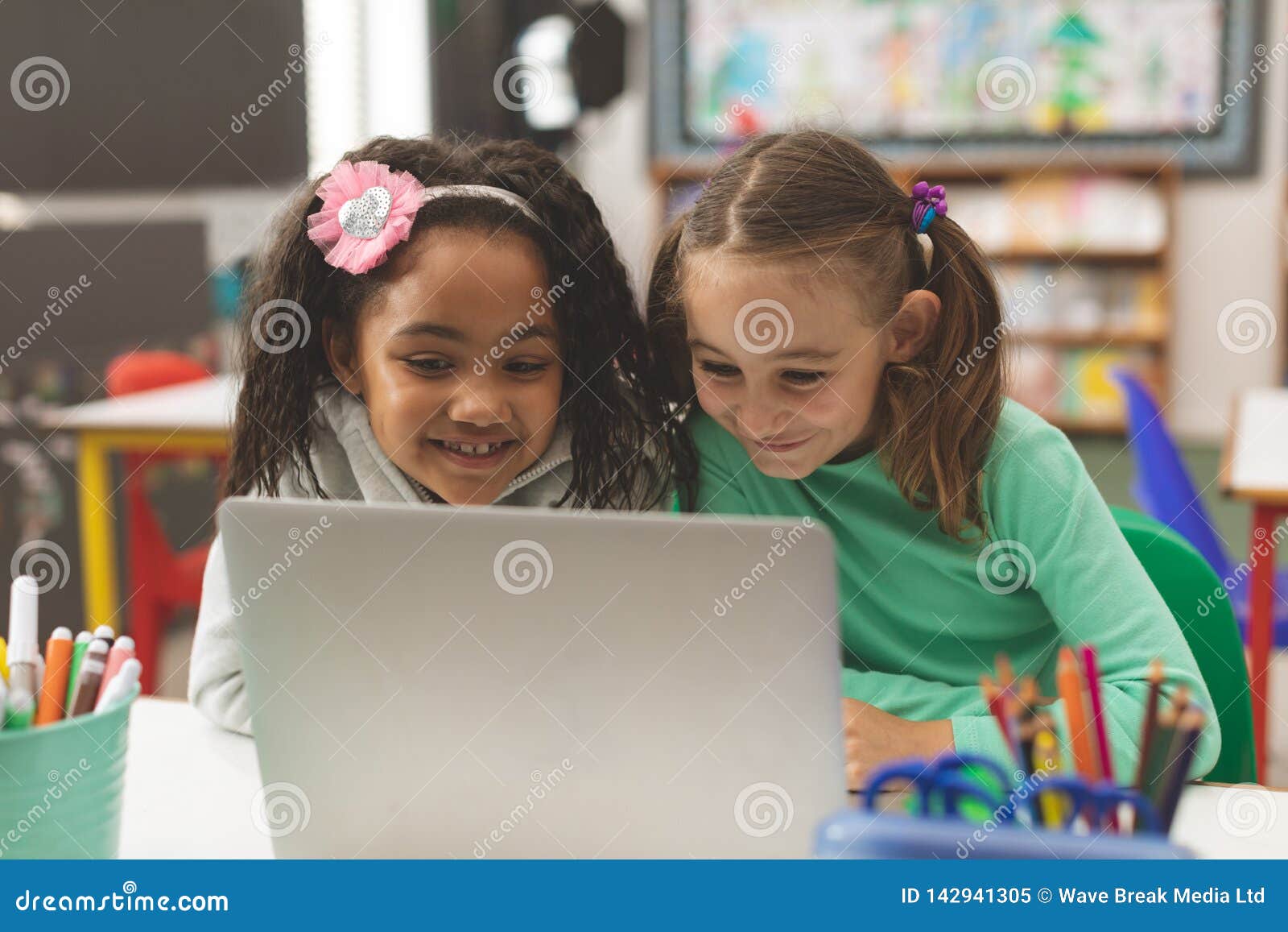 Surface Level View of Two Schoolgirl Smiling while they Working on ...