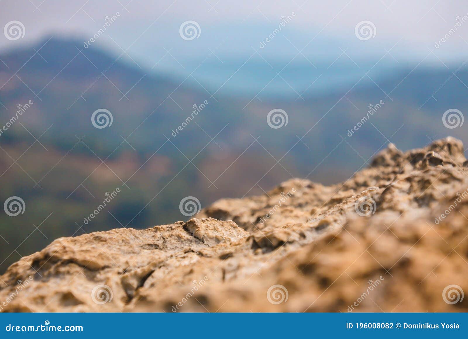 A Surface of a Rock with Blurry Mountain Background Stock Photo - Image ...