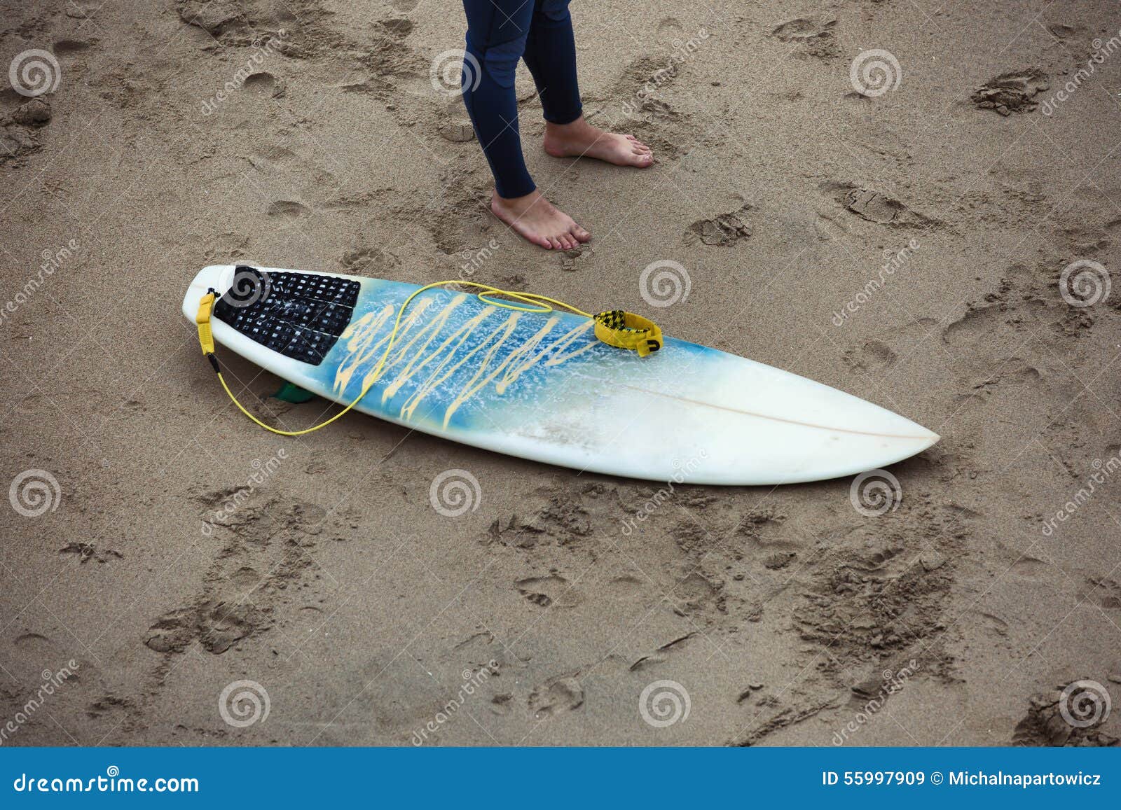 Surfboard on the Beach Next To the Surfer Legs. Stock Image - Image of ...