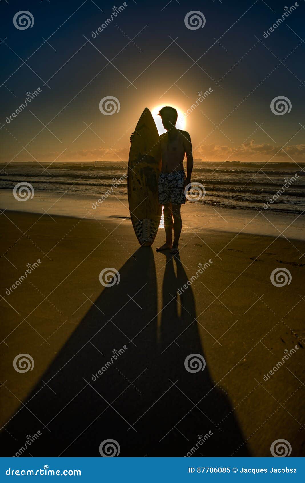 Surfer on Beach with Sun Directly from Behind Stock Image - Image of ...