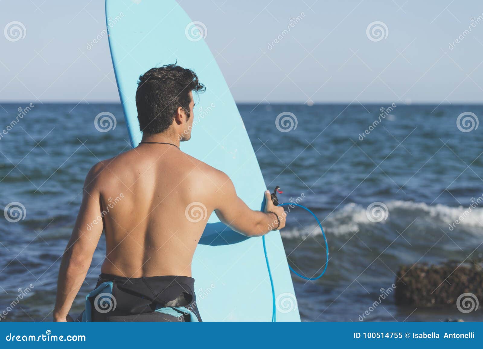 Surfer Carrying His Blue Surfboard from Behind Stock Image - Image of ...