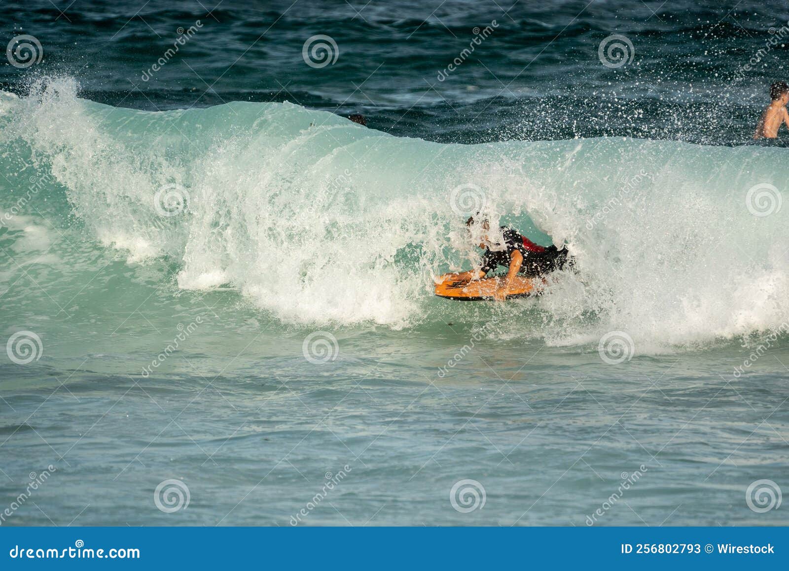 Surfer Catching a Wave, Wearing a Black Wetsuit. Stock Image - Image of ...