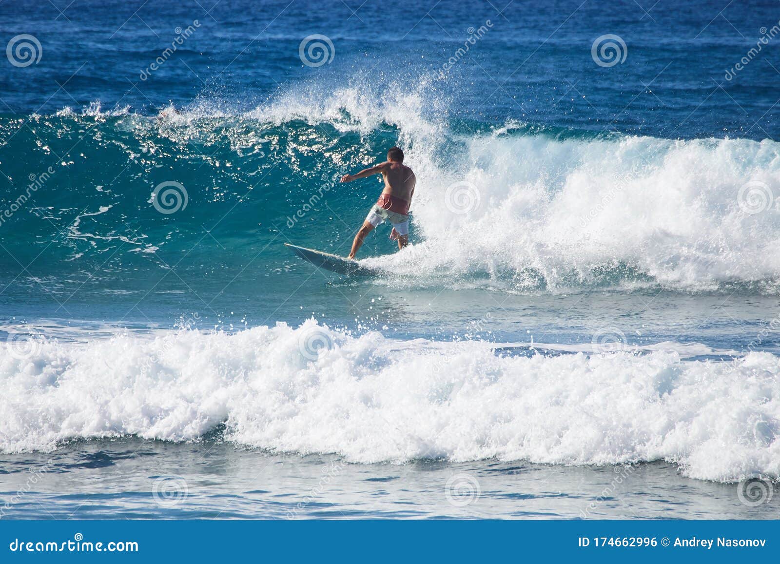 Surfer Rides at High Speed on a Wave Stock Photo - Image of blue ...