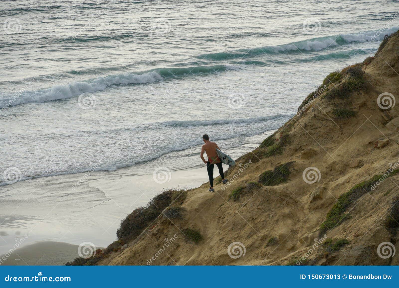 Surfer with His Surf Standing at the Cliff and Looking at the Waves ...