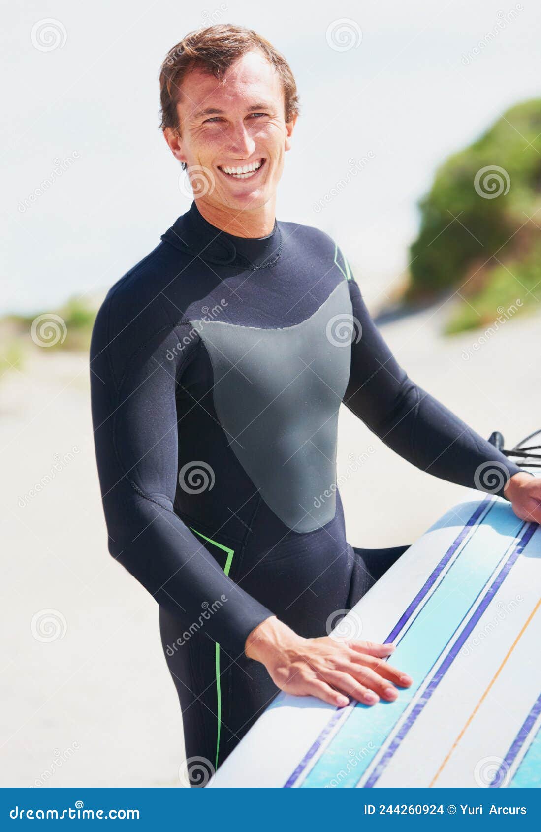 Ready To Hit the Waves. a Surfer Resting His Board on His Leg Getting ...