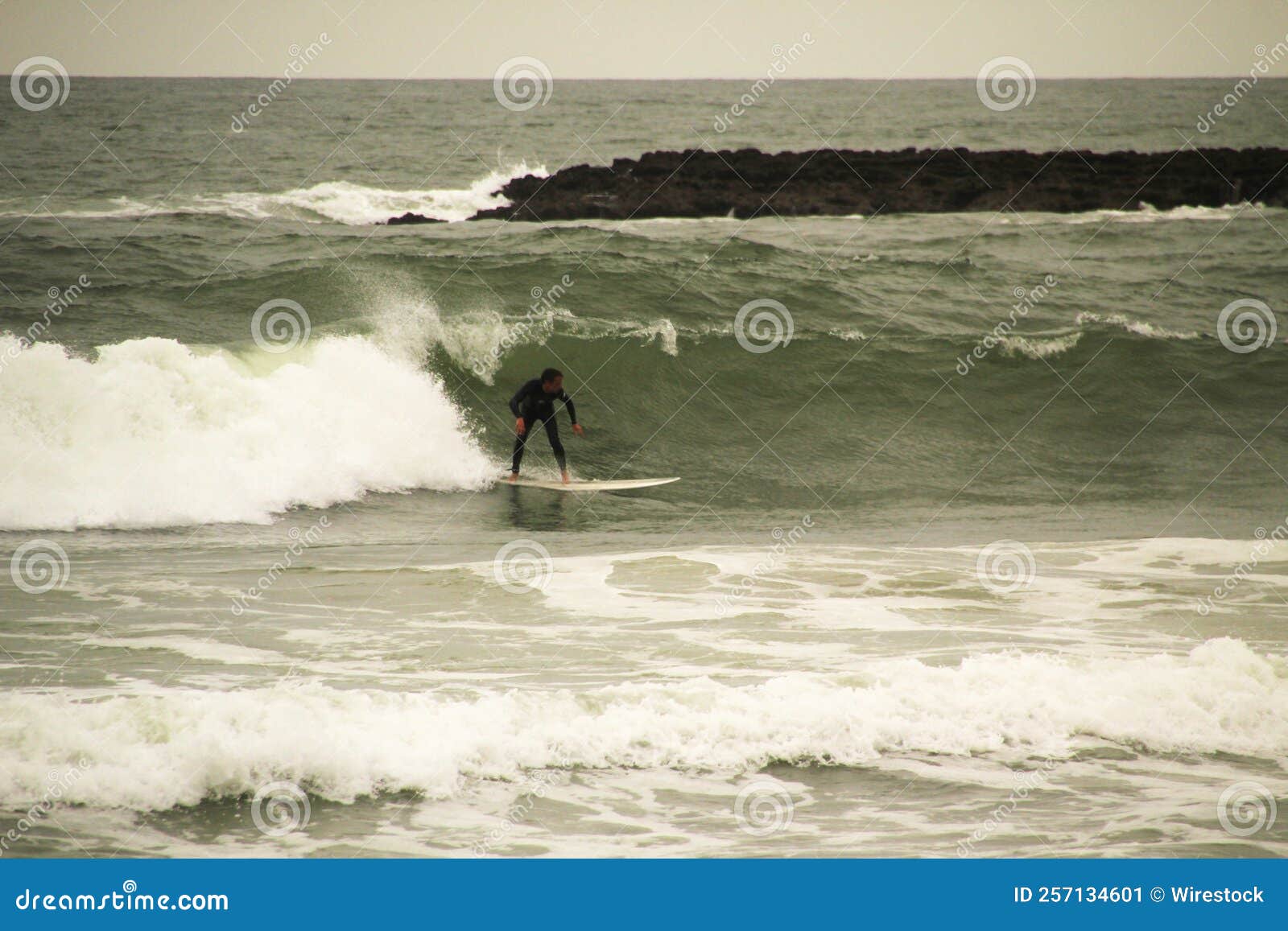 Surfer on the Sea with Big Waves Behind Him Stock Image - Image of ...