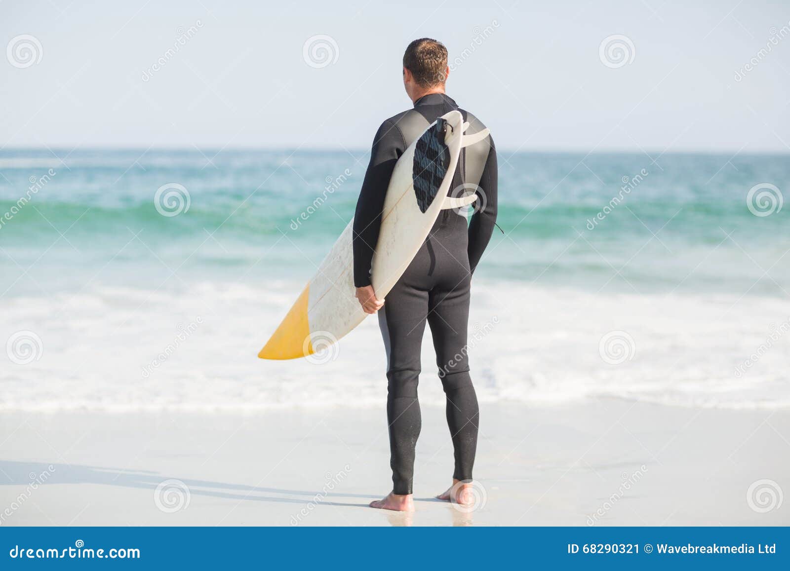 Surfer Standing on the Beach with a Surfboard Stock Image - Image of ...