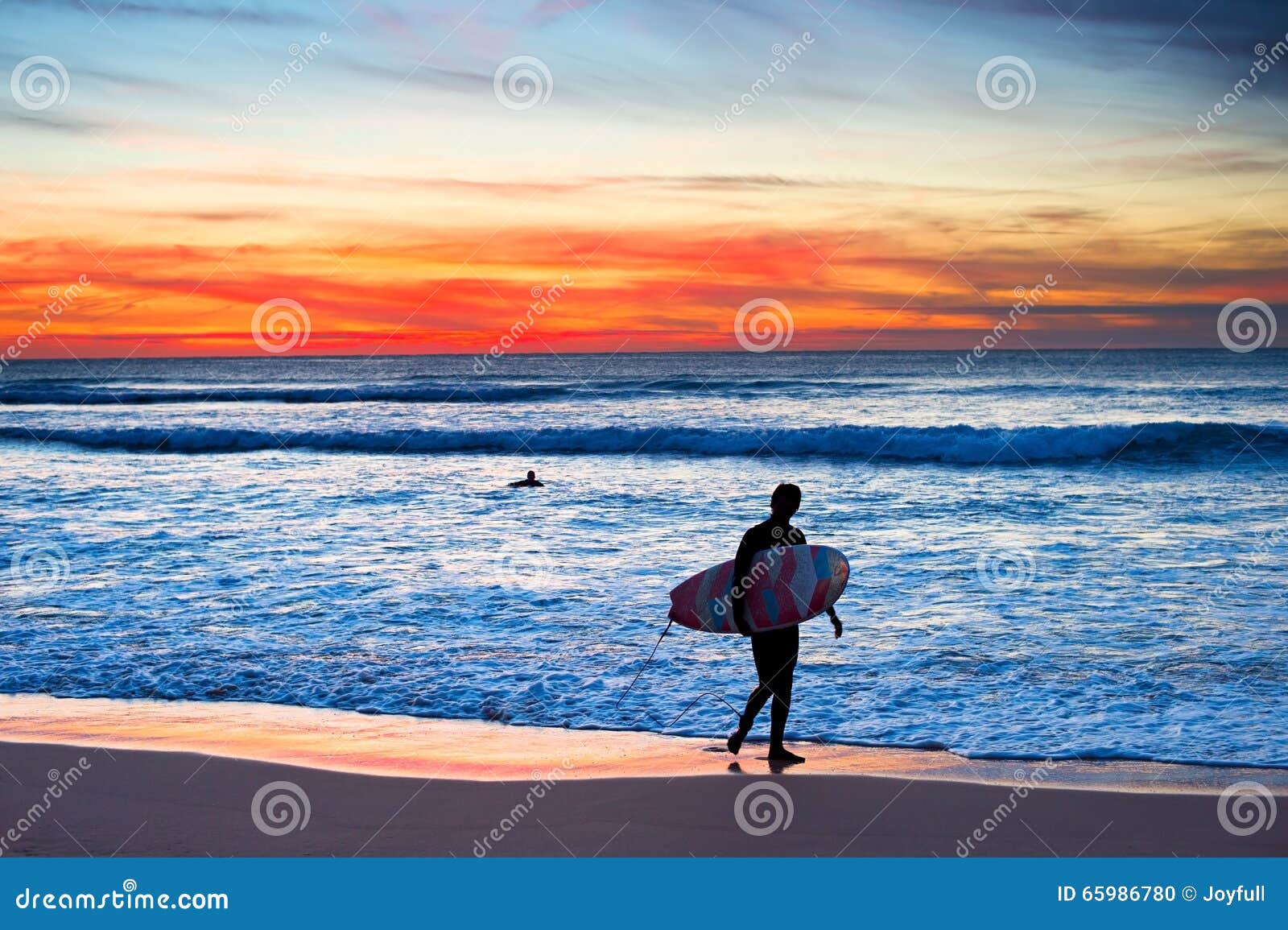 Surfer at sunset stock photo. Image of strolling, silhouette - 65986780