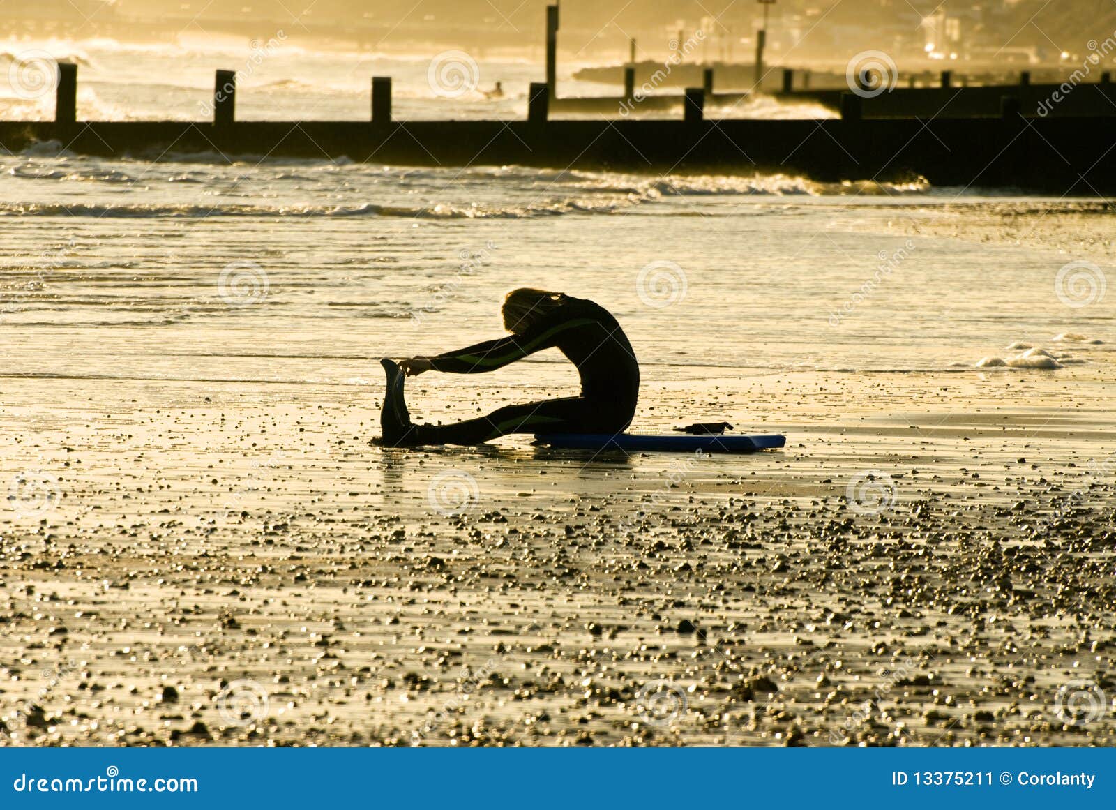 Surferr Stretching on the Beach Stock Image - Image of athletic, colour ...