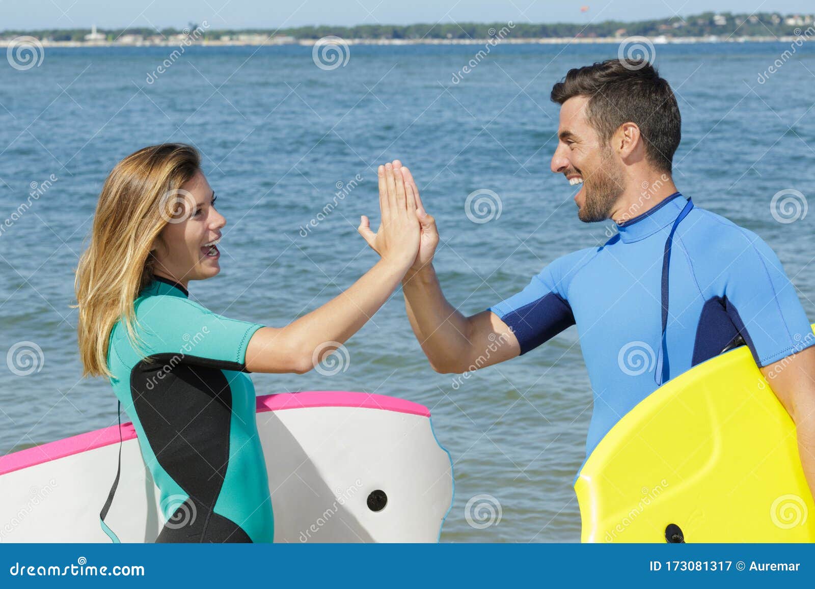 Surfing Couple Giving Each Other High Five Stock Image - Image of ...