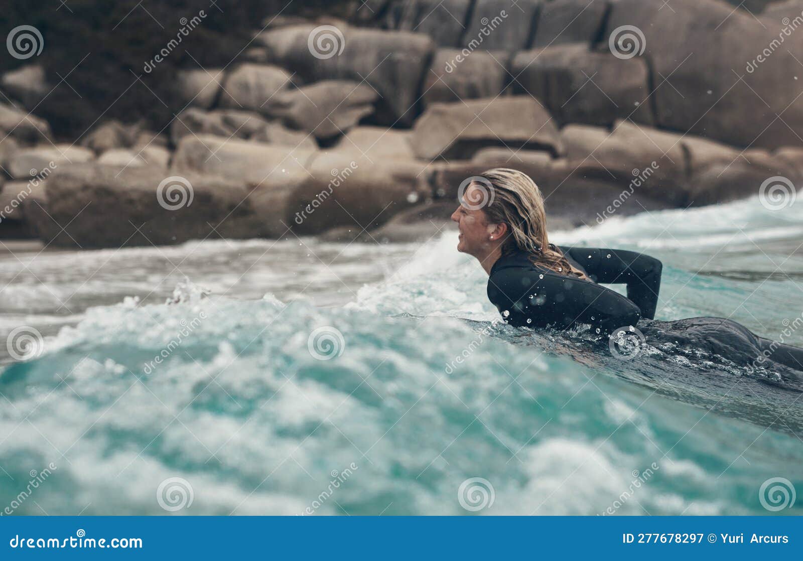 Surfing is a Magical Experience. a Young Woman Out Surfing at the Beach ...