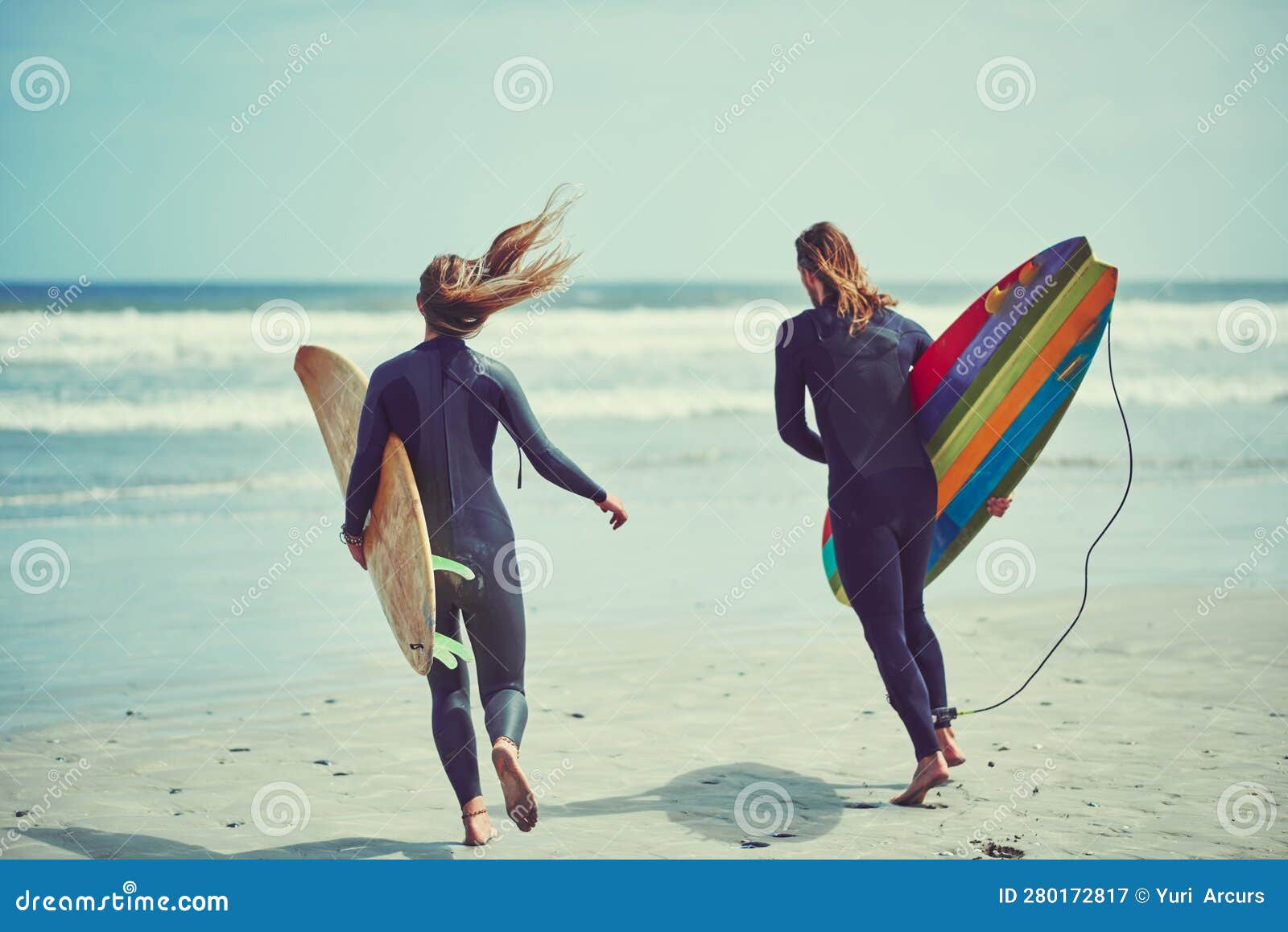 Surfing Power Couple. a Young Couple Surfing at the Beach. Stock Image ...