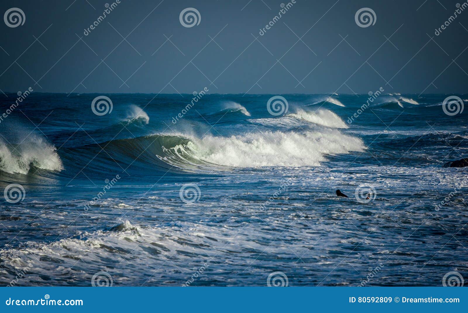 Surfing in the storm 1 stock image. Image of morning - 80592809