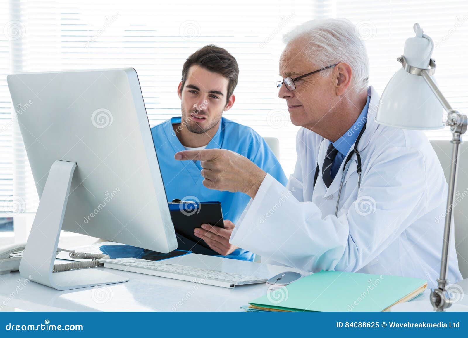 Surgeon and Doctor Discussing Over Personal Computer Stock Image ...
