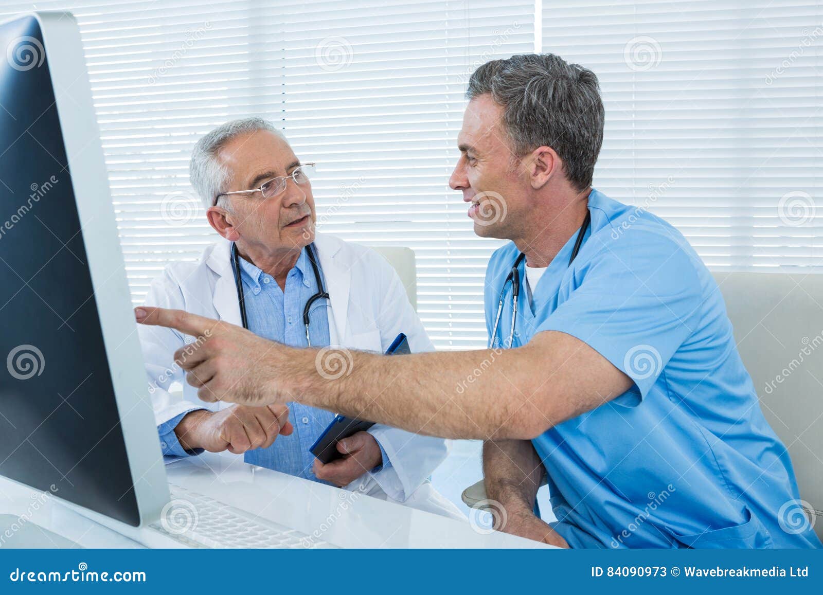 Surgeon and Doctor Discussing Over Personal Computer Stock Image ...