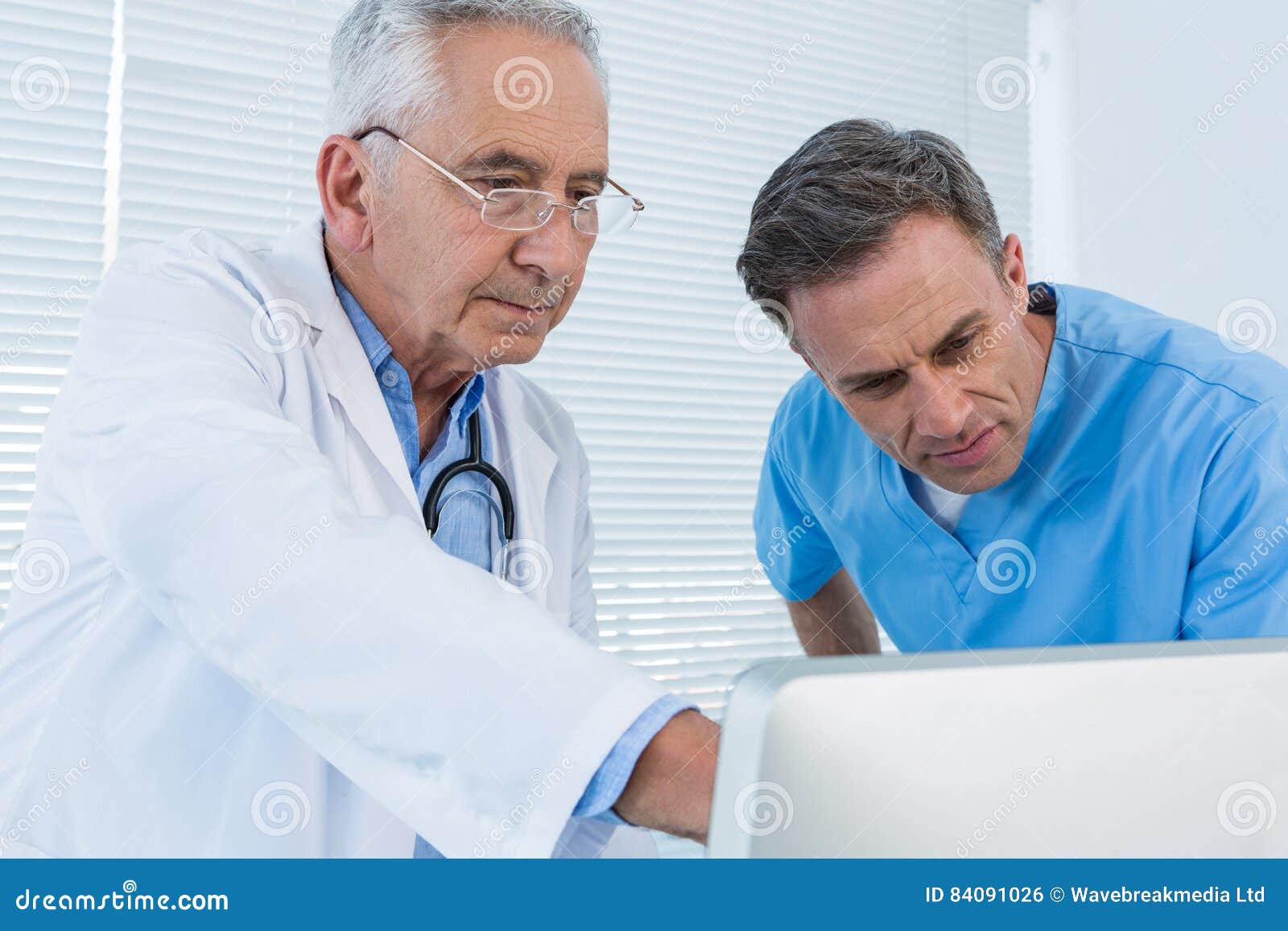 Surgeon and Doctor Discussing Over Personal Computer Stock Photo ...