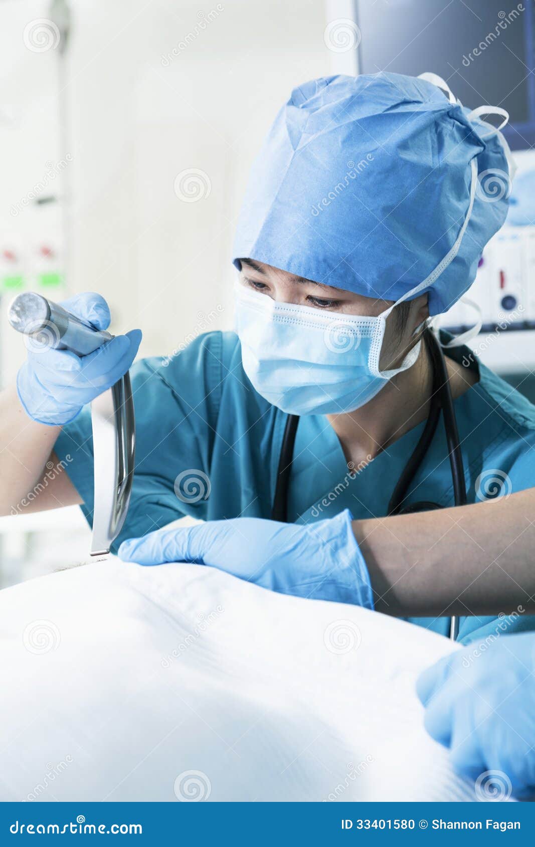 Surgeon Looking Down and Holding Surgical Equipment in the Operating ...
