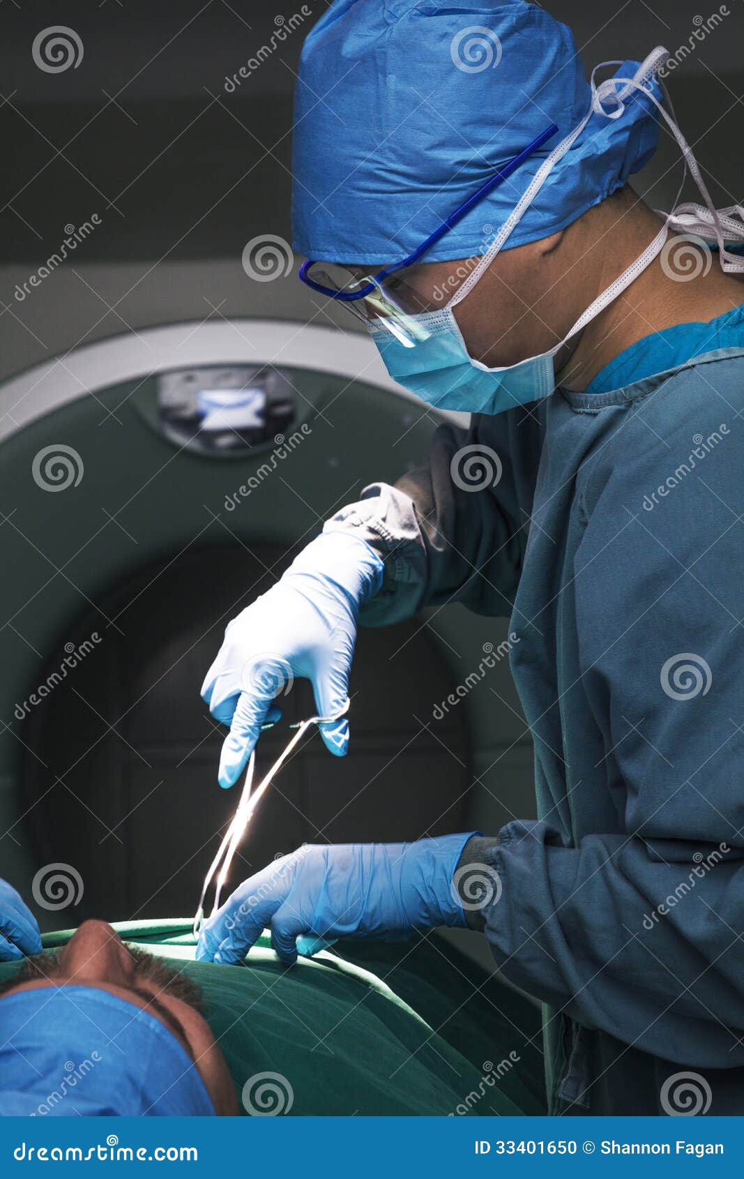 Surgeon Looking Down, Working, and Holding Surgical Equipment with ...