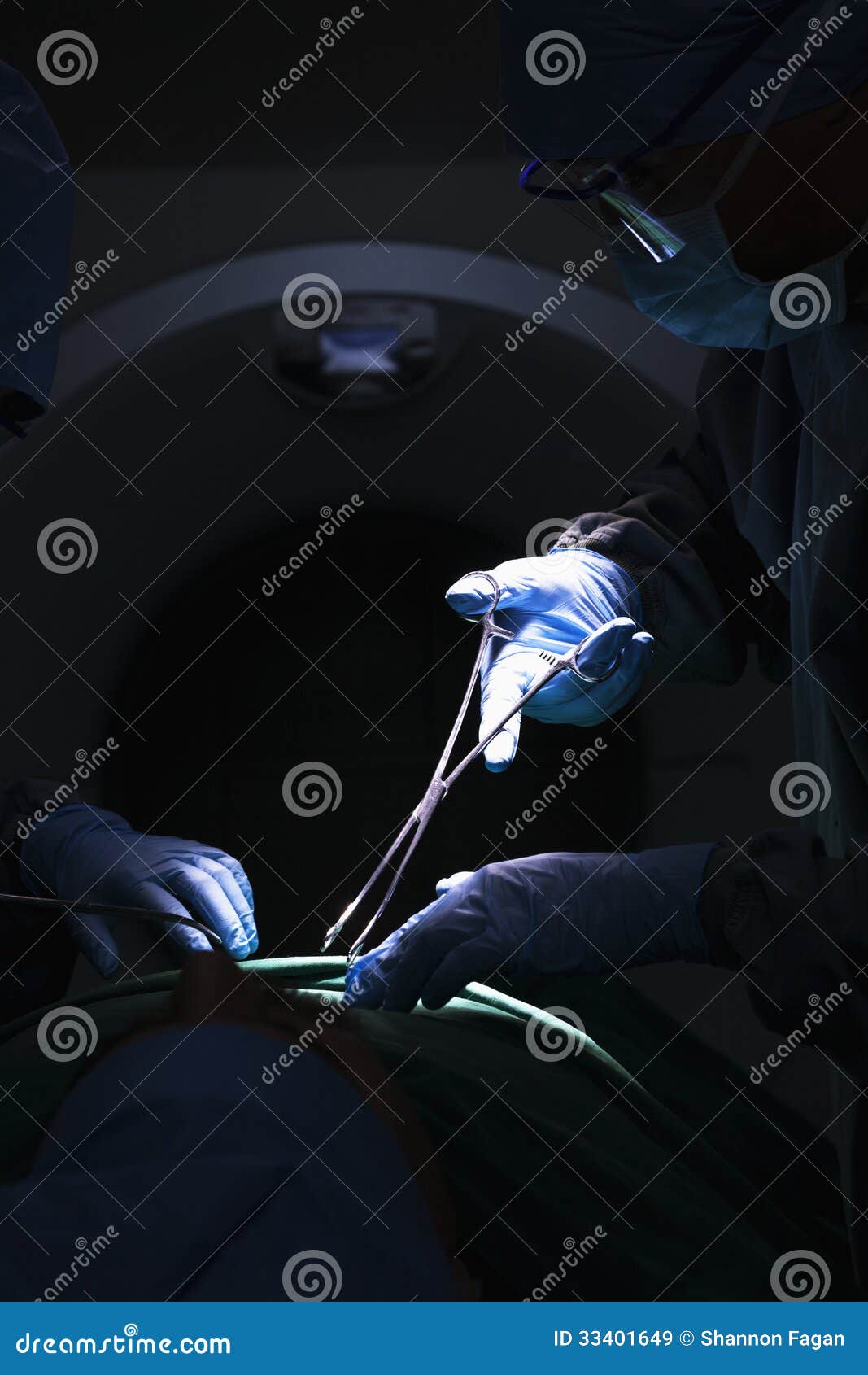 Surgeon Looking Down, Working, and Holding Surgical Equipment with ...