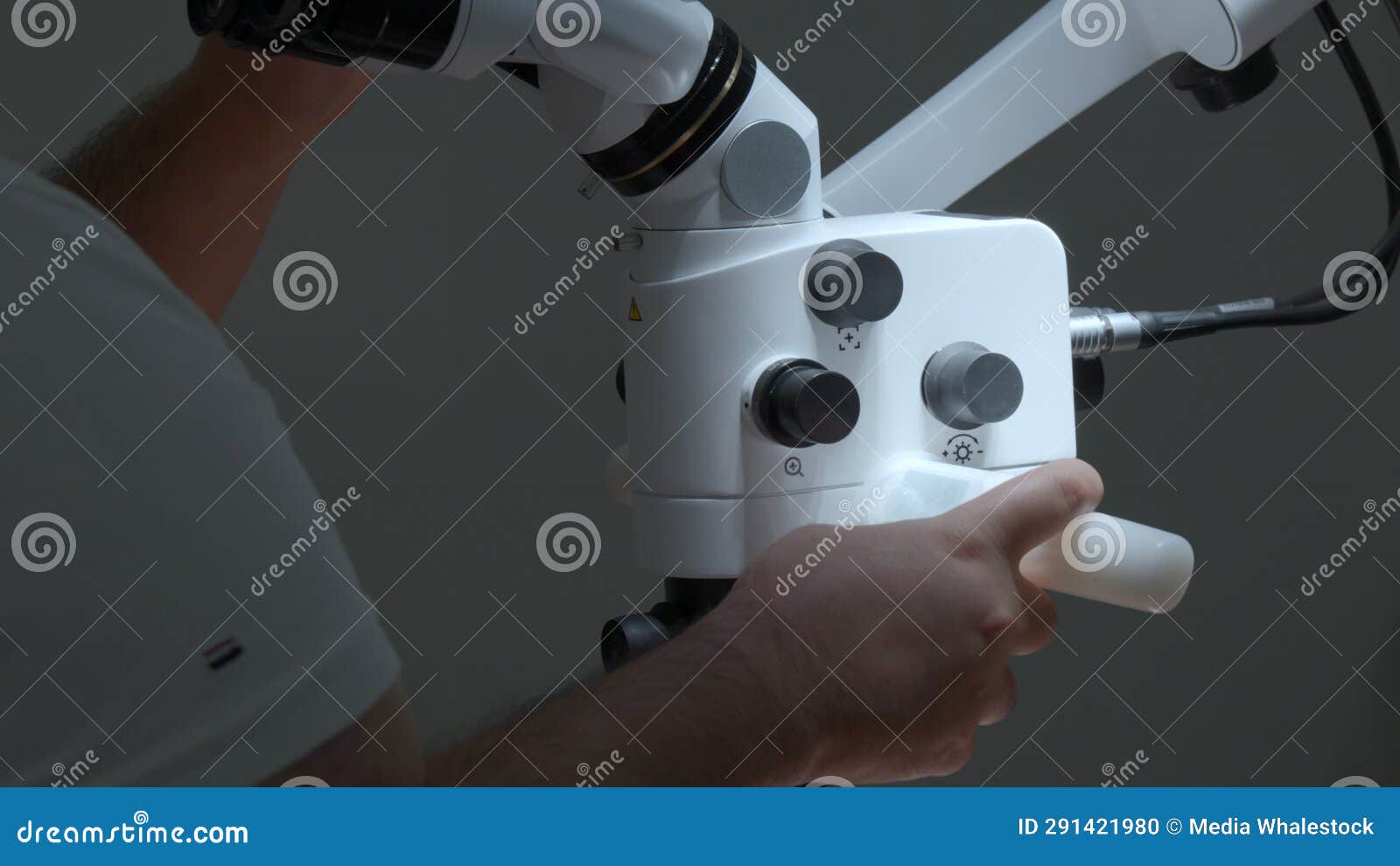 Surgeon Looking into the Microscope at the Operating Room. Action ...