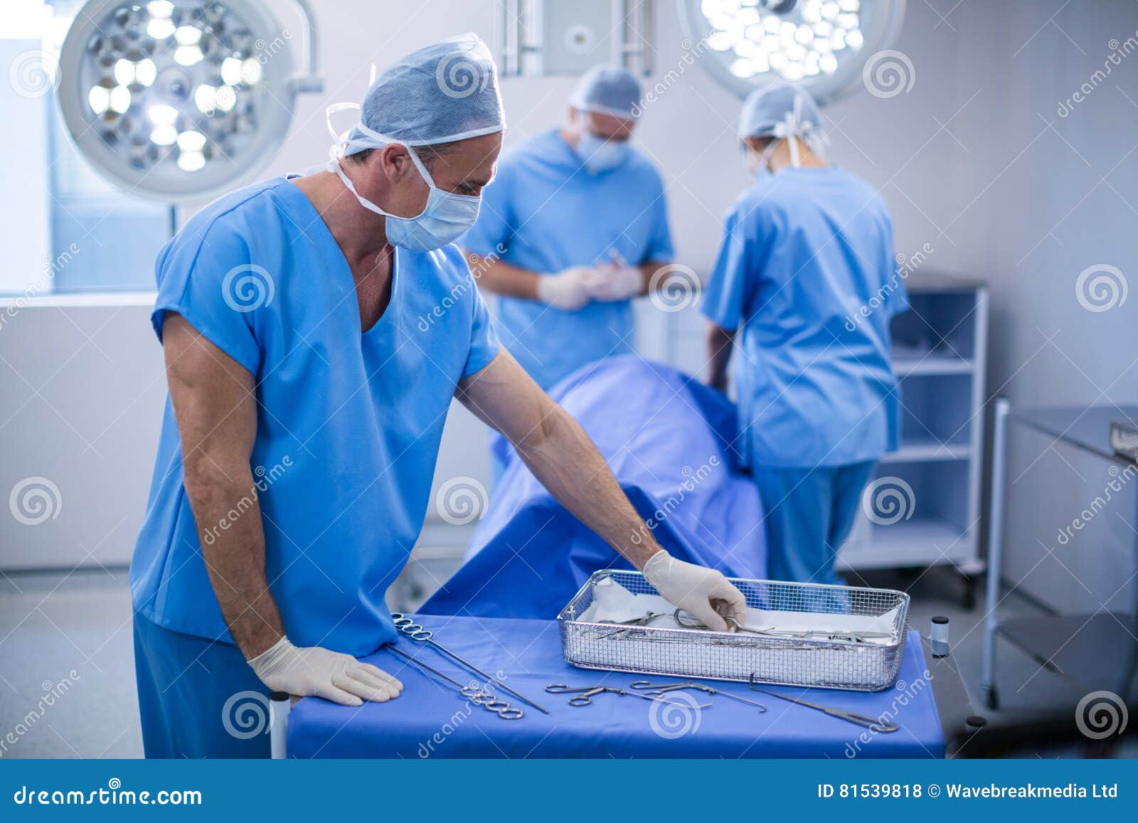 Surgeon Removing Surgical Tools from Tray in Operation Room Stock Photo ...